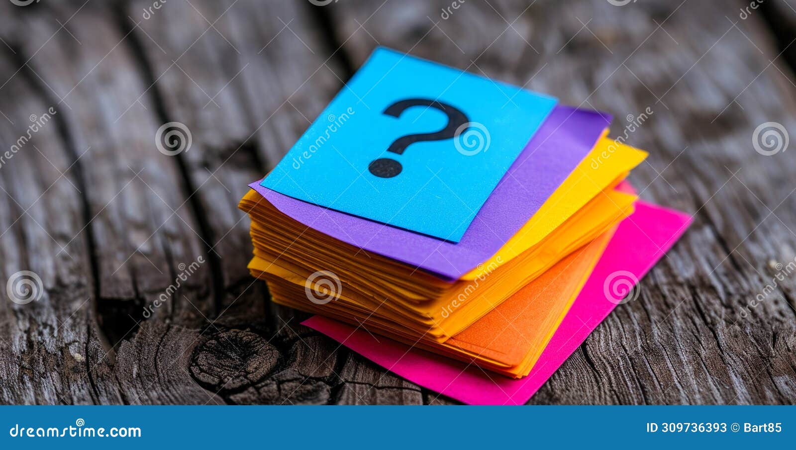 Stack of Colorful Sticky Notes on Wooden Background with a Prominent ...