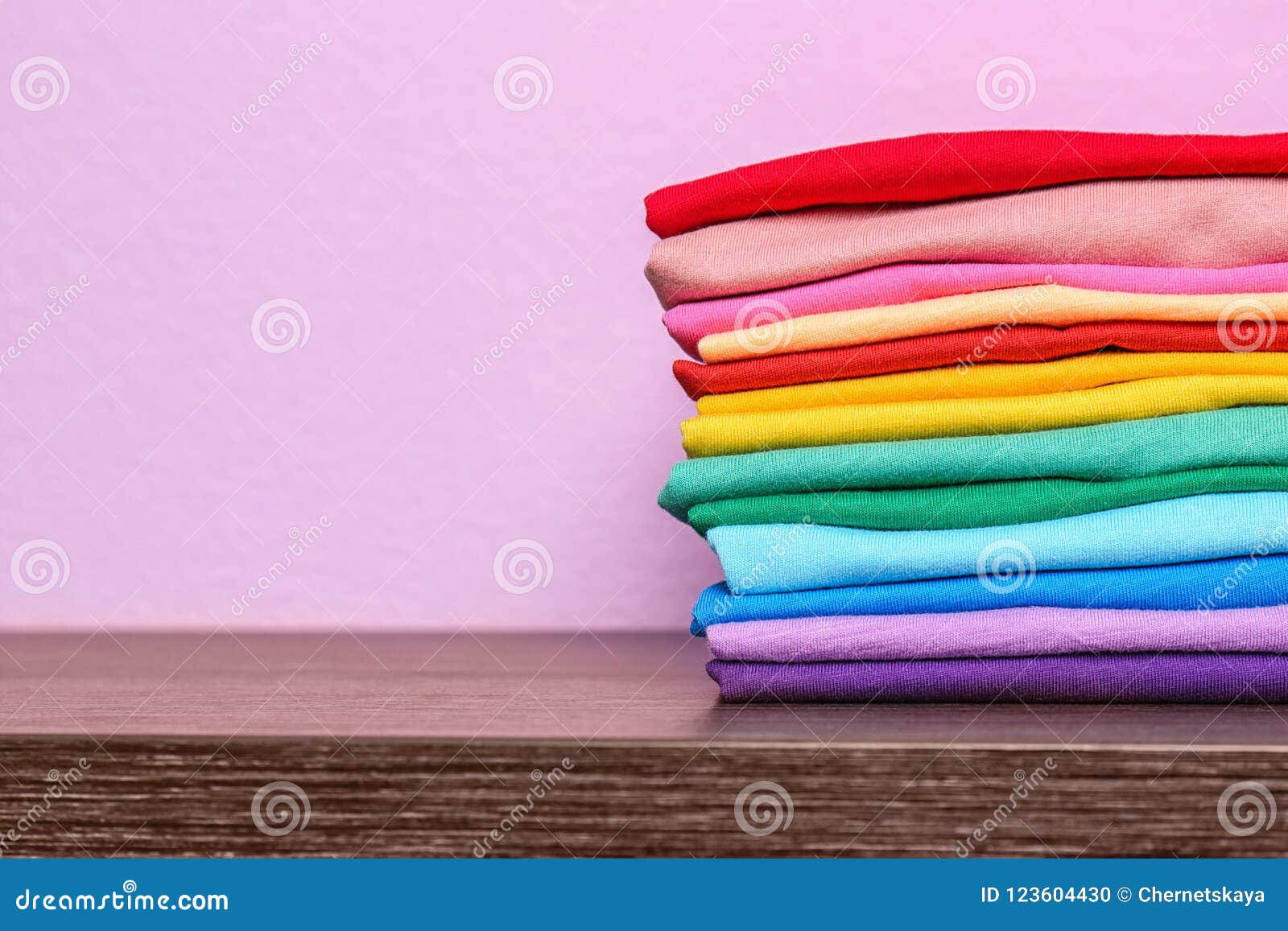 Stack of Colorful T-shirts on Table Stock Photo - Image of cotton, pile ...