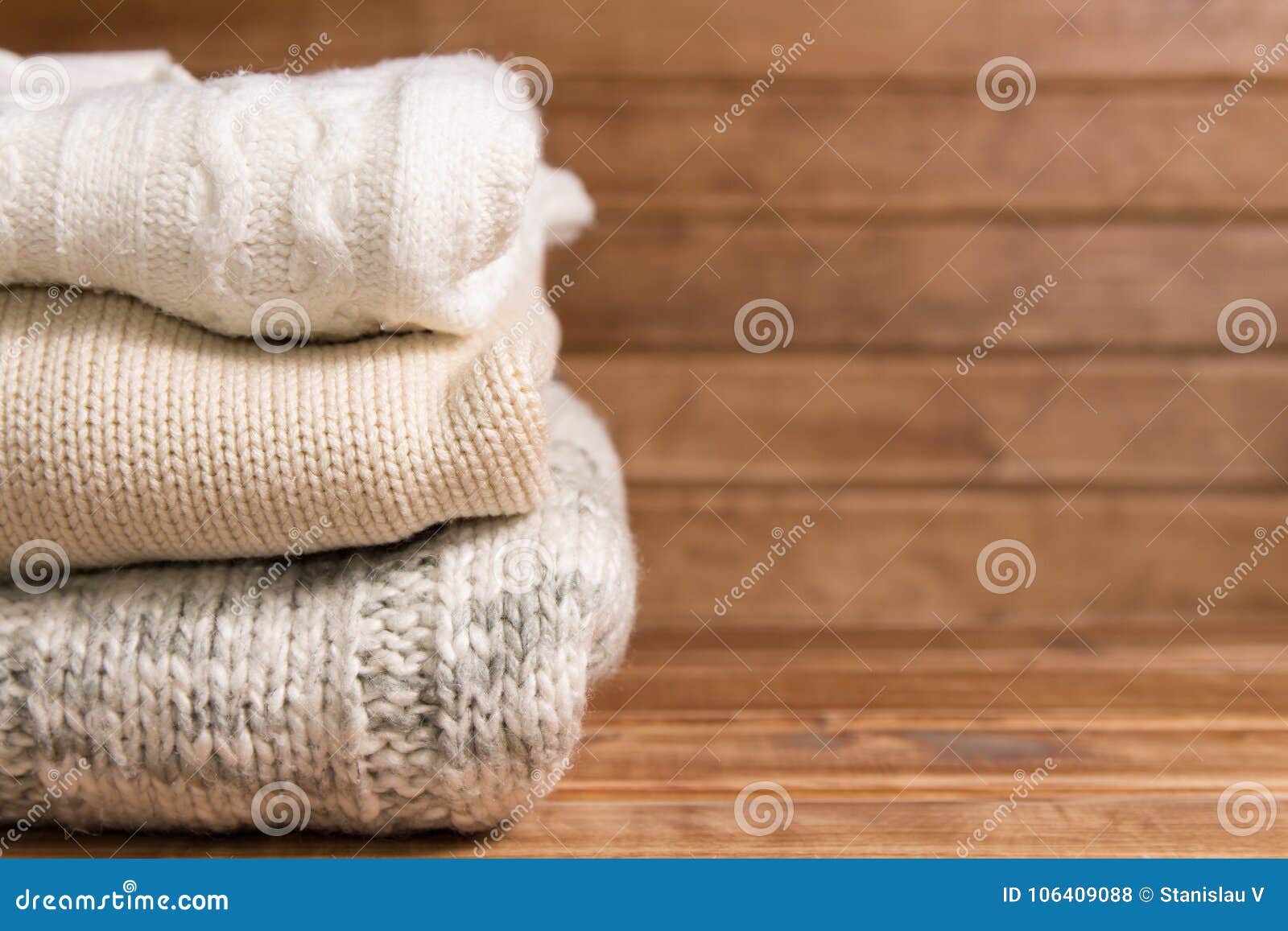 Stack of Cozy Knitted Warm Sweater ,wooden Background . White Sweaters ...
