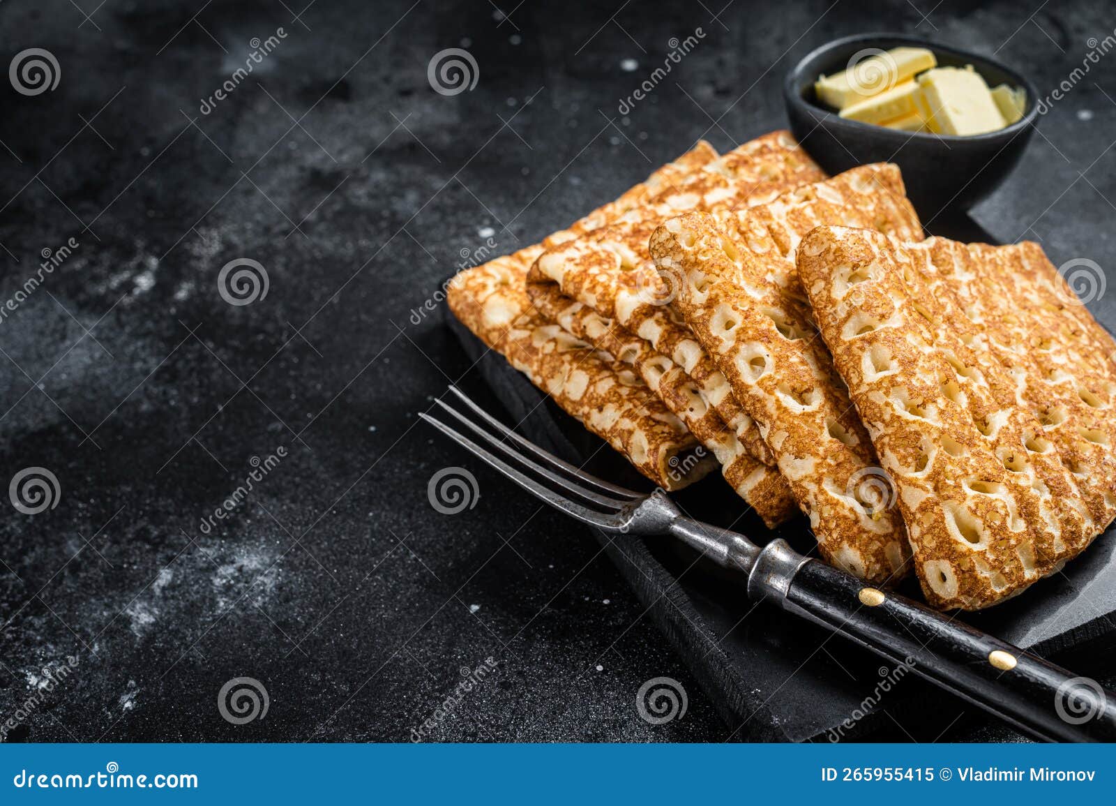 Stack of Crepes with Butter on a Marble Board. Black Background. Top ...