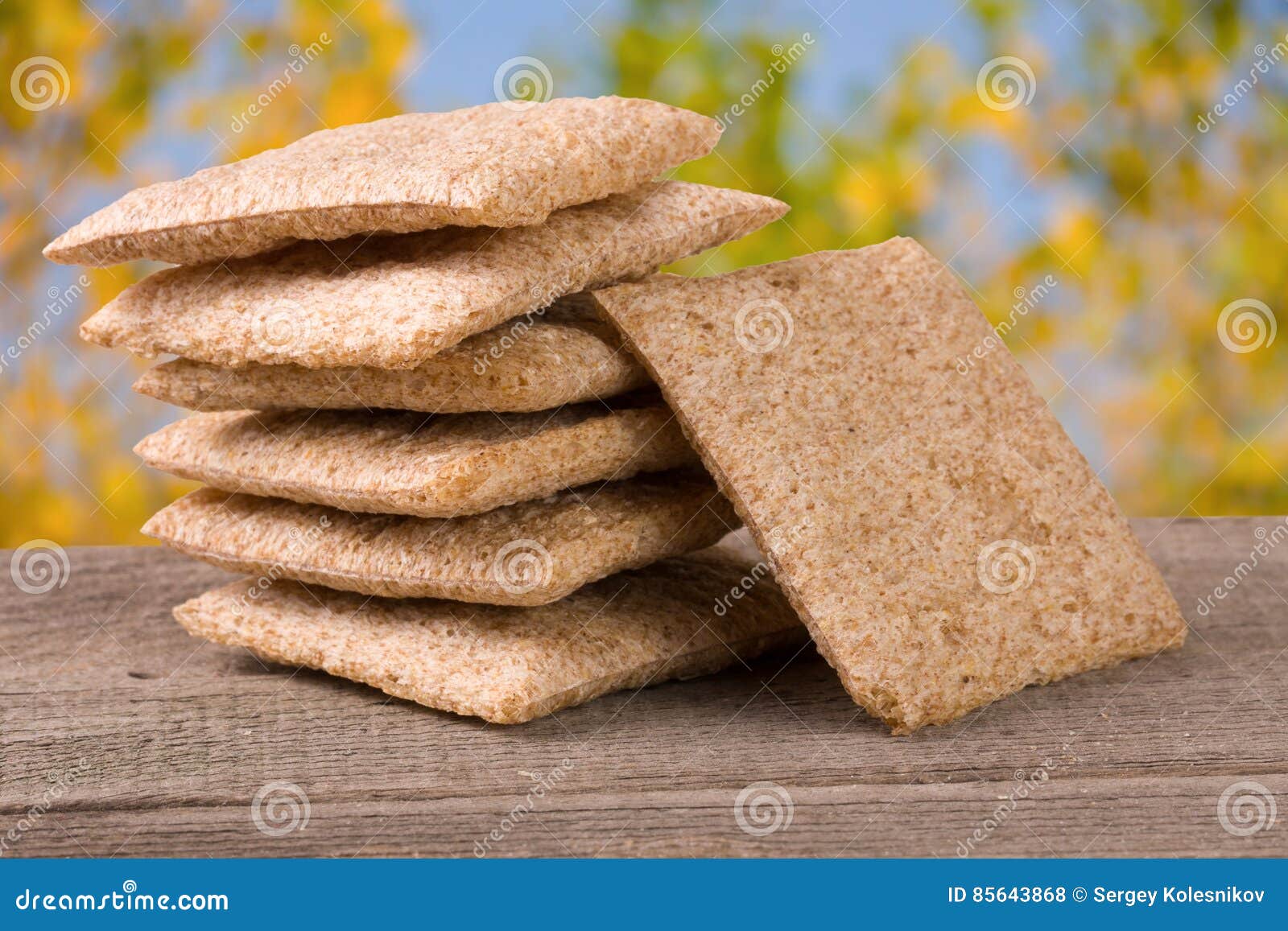 Stack of Crisp Bread on a Wooden Table with Blurred Garden Background ...
