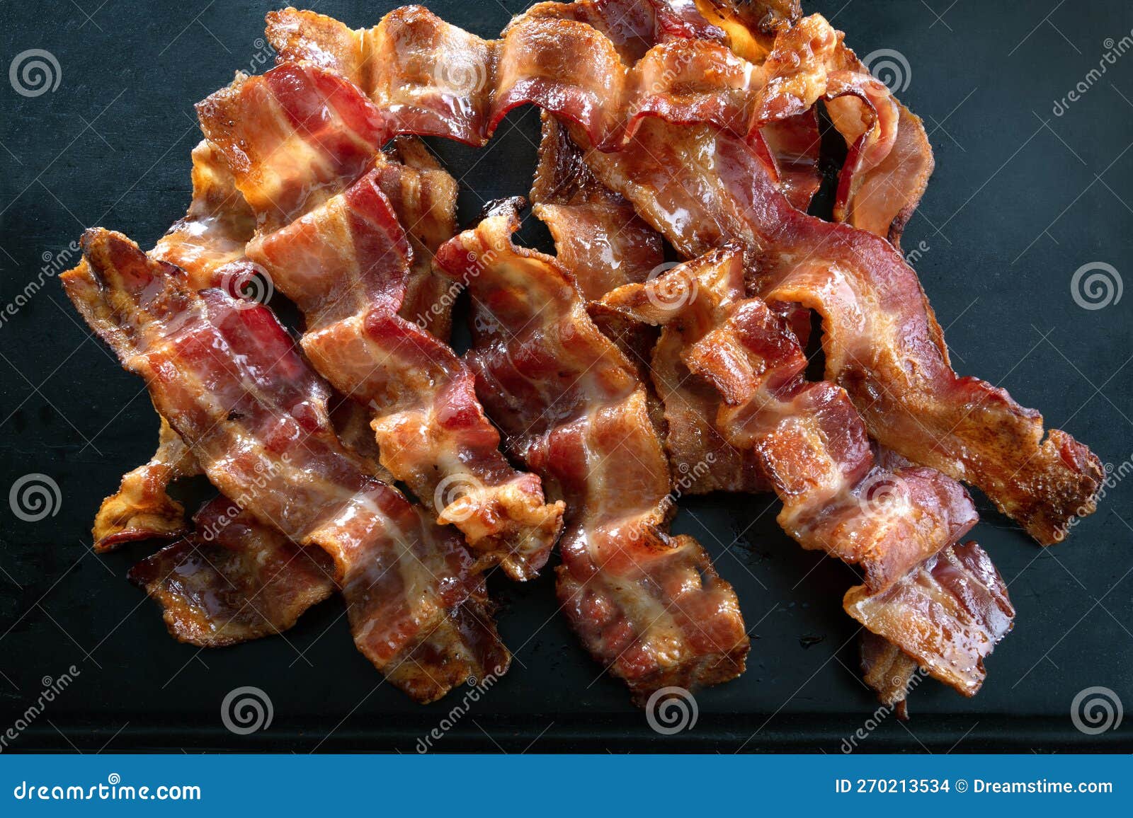 Crispy Strips of Bacon Overlapping on a Dark Surface Top Angle Stock ...