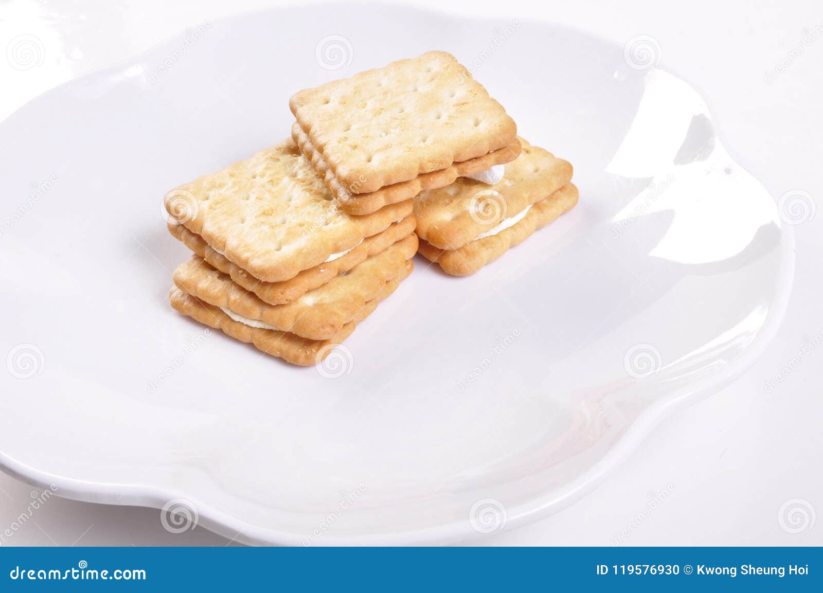 A Stack of Delicious Wheat Square Biscuits with Cream on White Dish ...