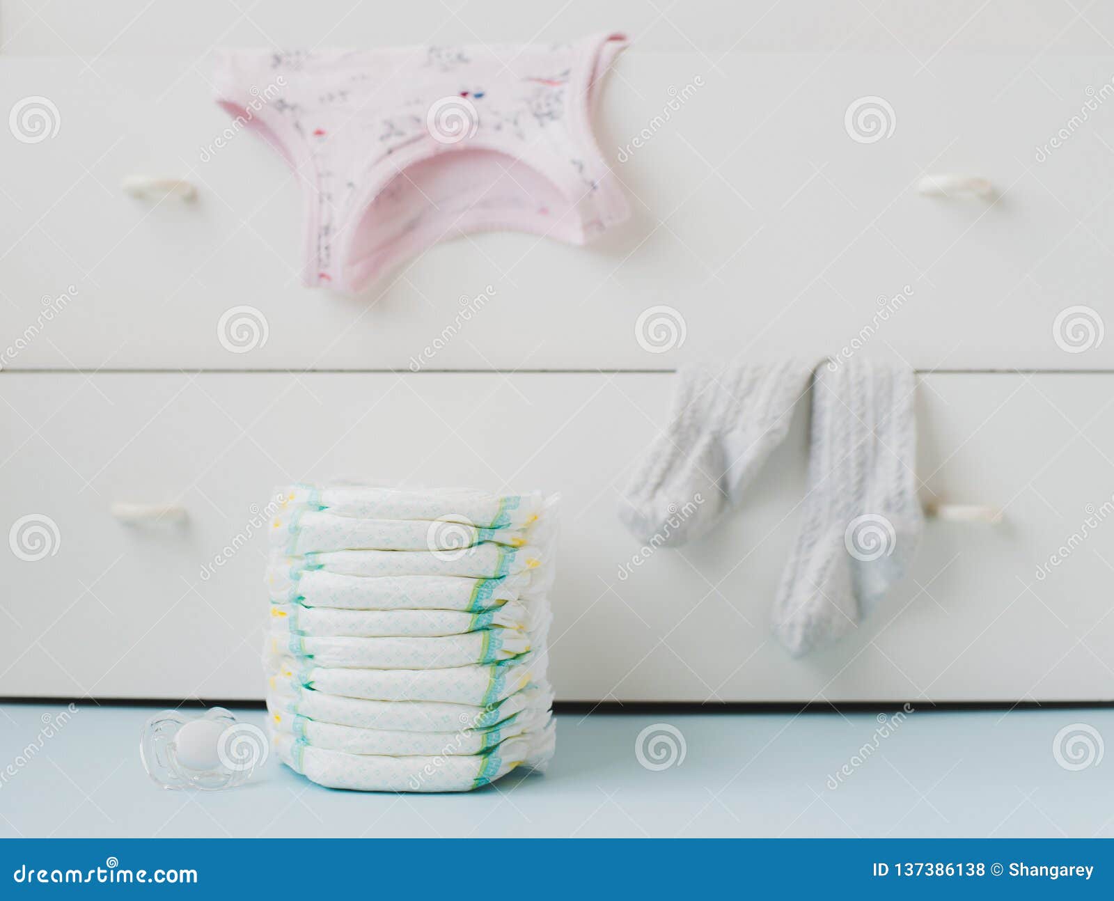 A Stack of Diapers and a Locker with Linens Stock Photo - Image of ...