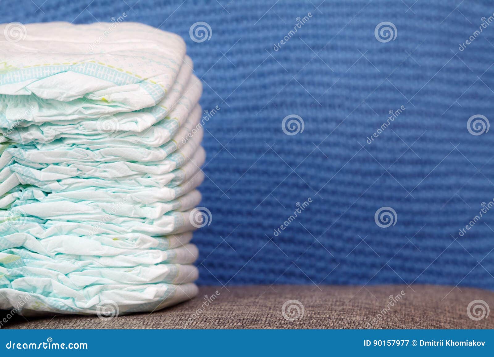 Stack of Diapers or Nappies on Blue Knitted Background Stock Image ...