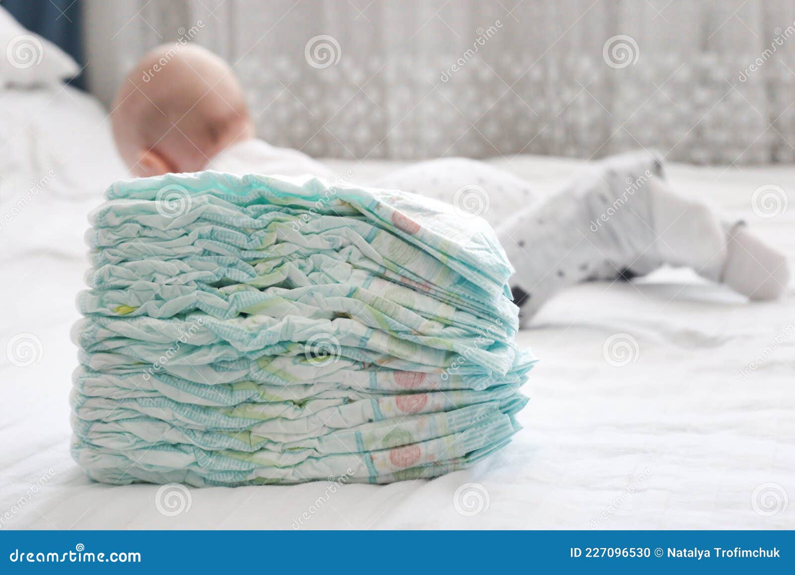 Stack Of Diapers And Soother In The Hands Of A Pregnant Woman Royalty ...