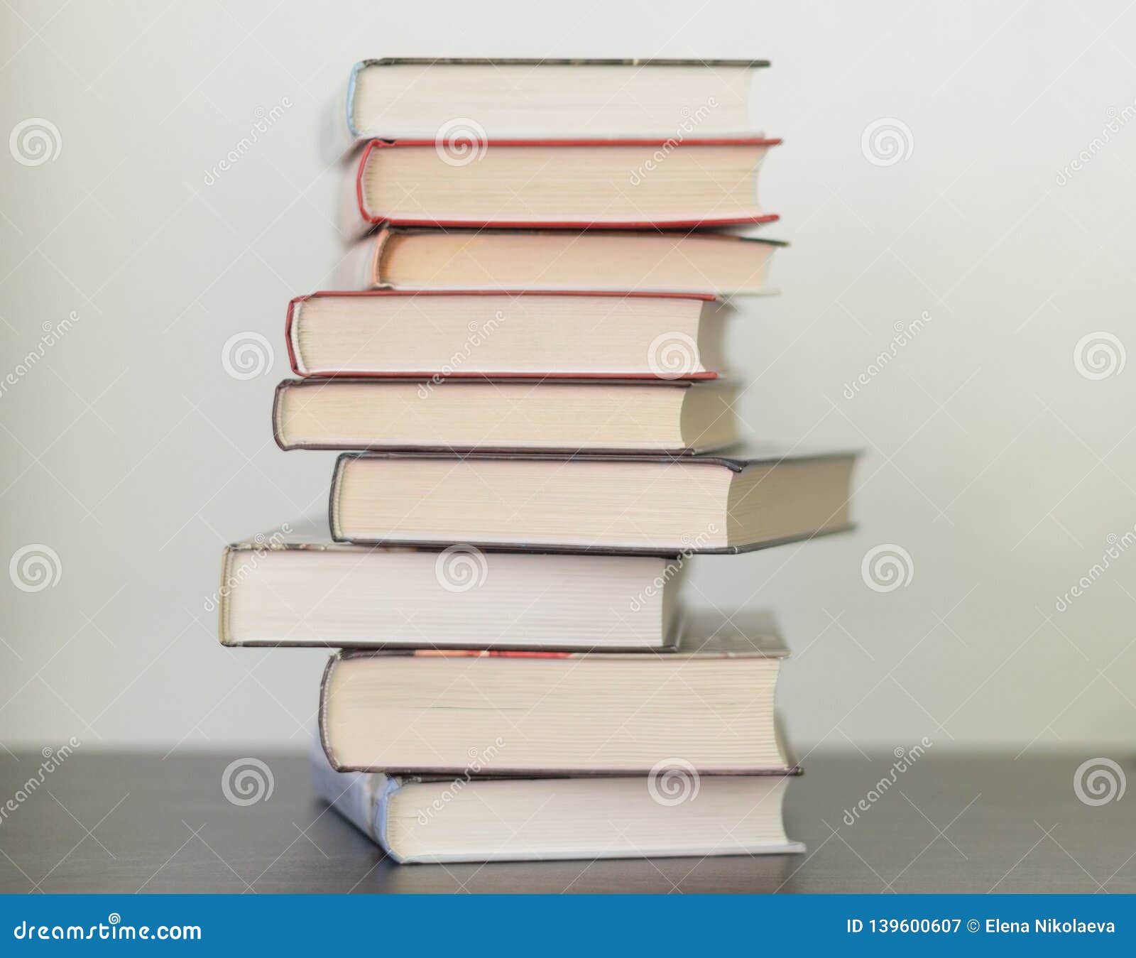 A Stack of Different Books in a Thick Cover on the Table Stock Image ...