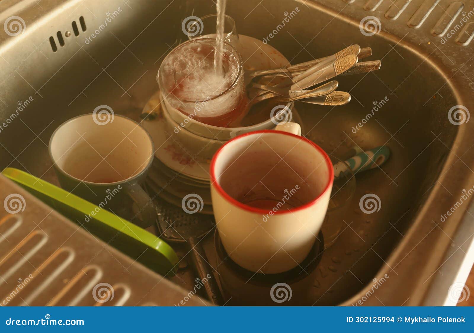 Stack of Dirty Dishes with Food Leftovers in the Kitchen Sink. Unwashed ...
