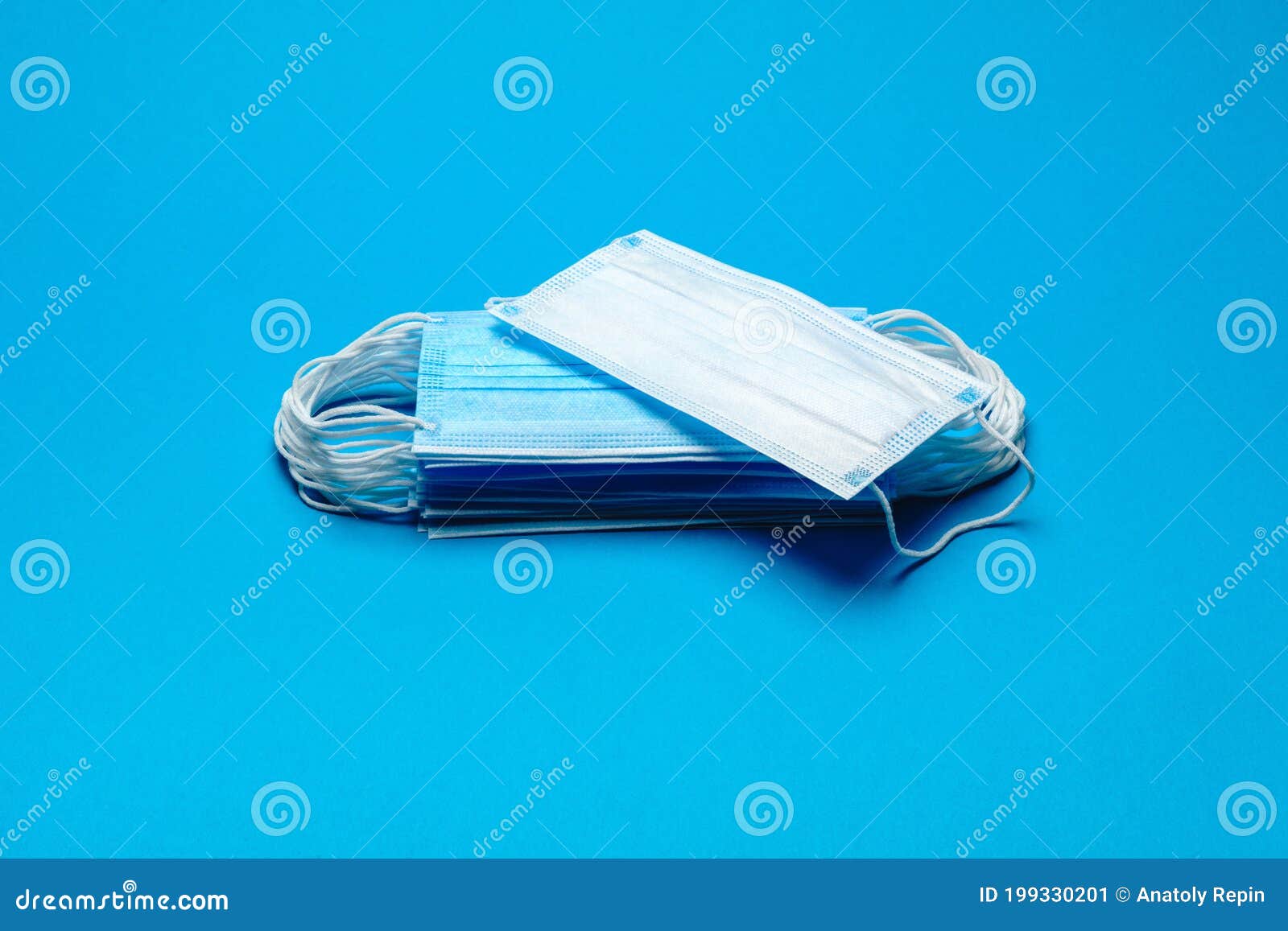 Stack of Disposable Blue Medical Face Masks on Blue Background Stock ...