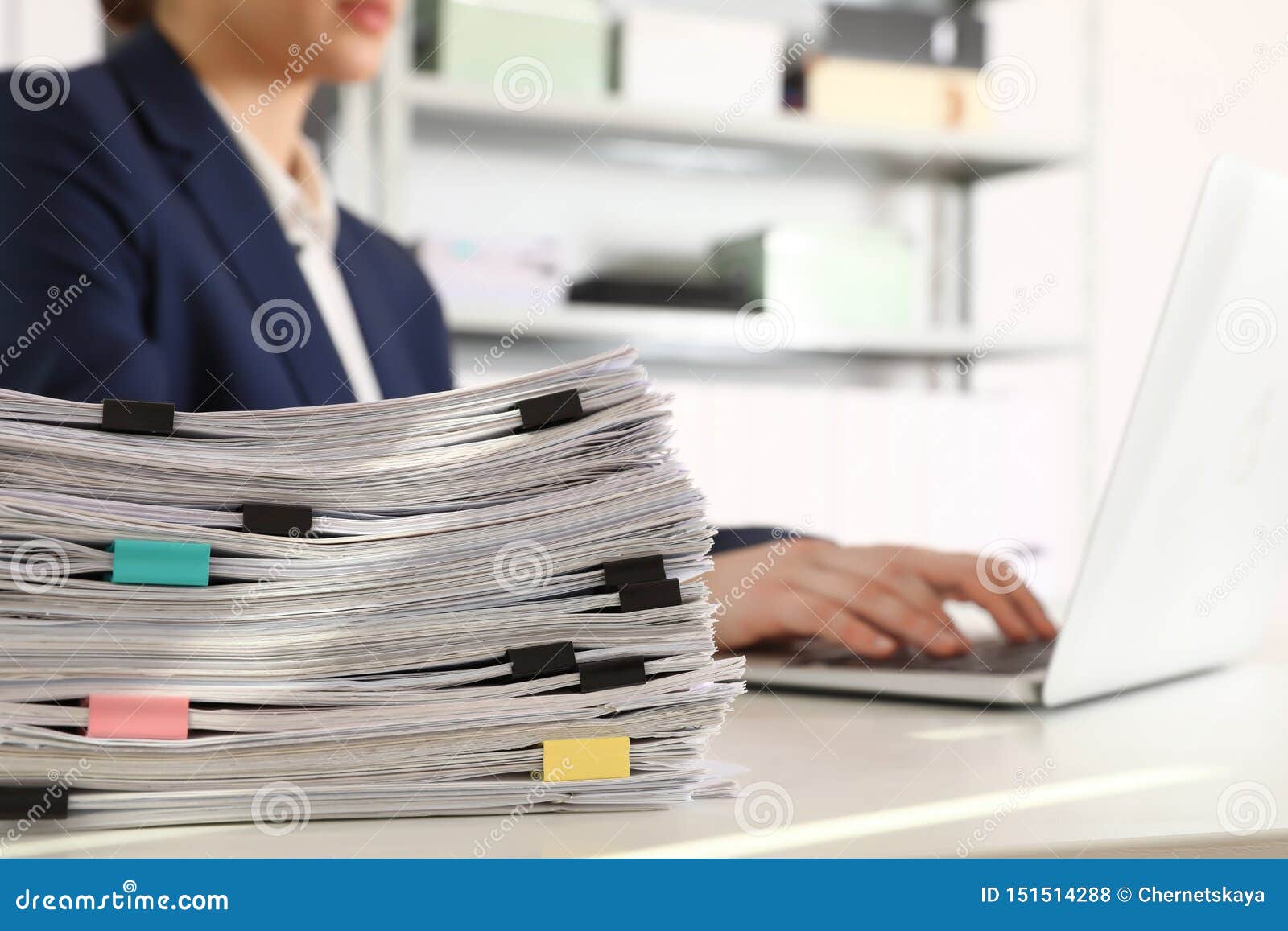 Stack of Documents and Woman Working with Laptop at Table in Office ...