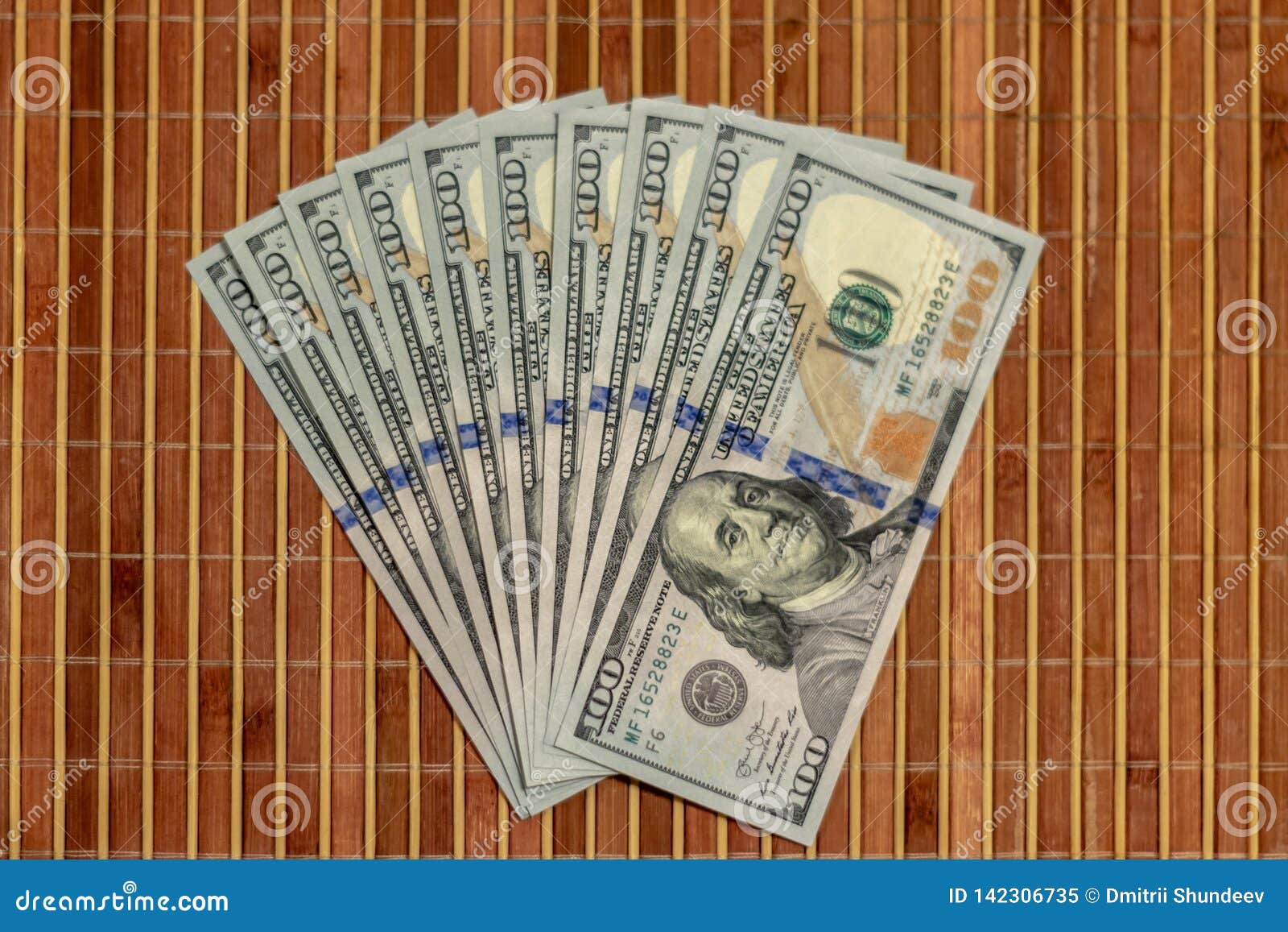 The Stack is 100 Dollar Bills USD Spread Out Like a Fan, on a Wooden ...