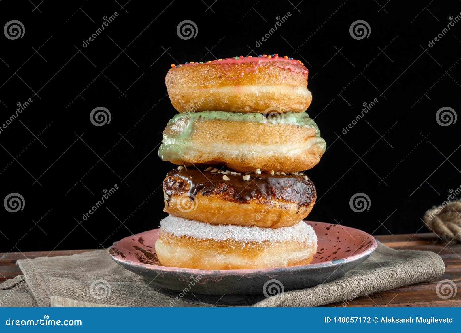 A Stack Of 4 Donuts On A Wooden Tray And A Black Background. Stock ...