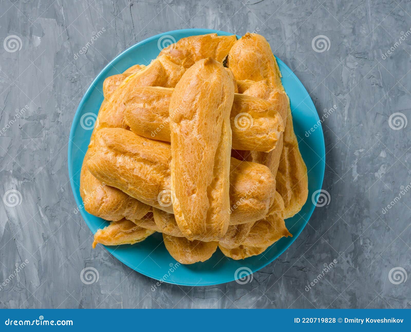 Stack of Eclairs on a Blue Plate on a Gray Background. Stock Photo ...