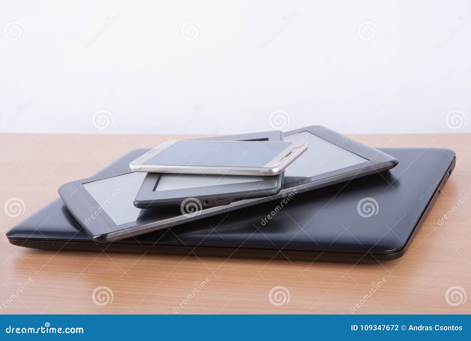 Stack of Electronic Gadgets on a Table - Notebook, Tablet, Ebook Reader ...