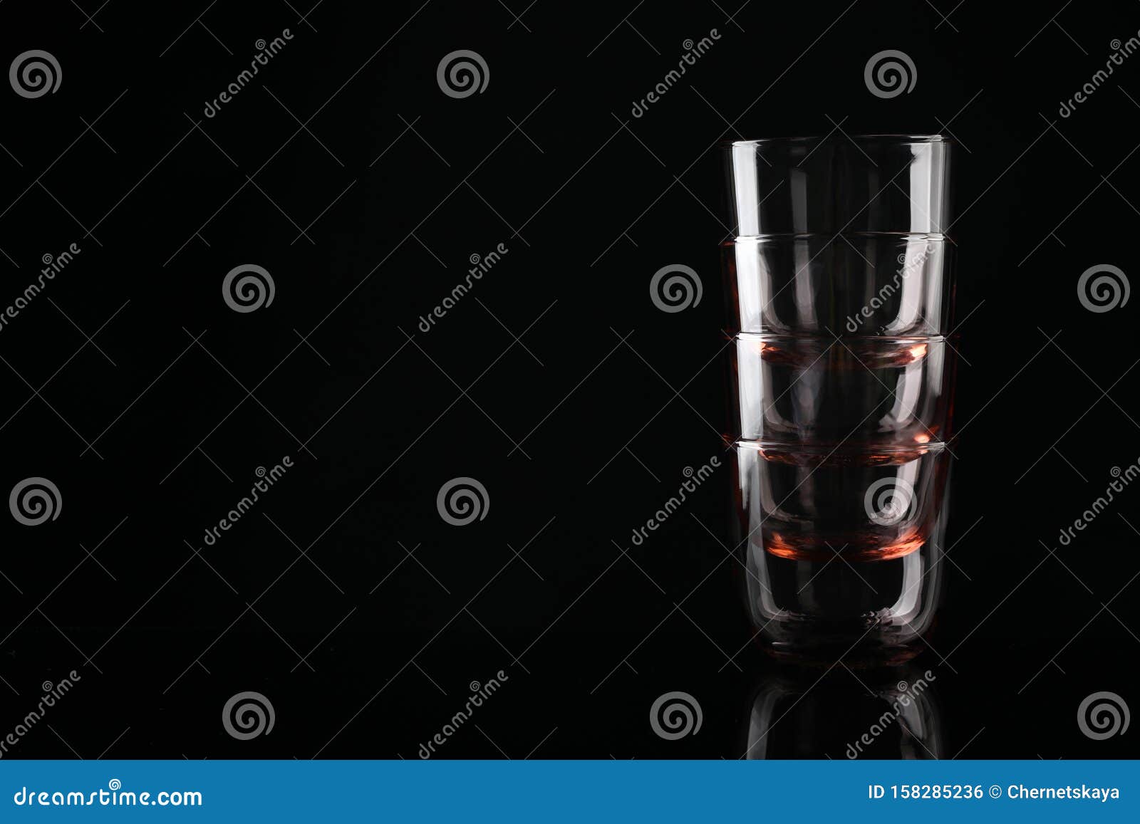 Stack of Empty Colorful Whiskey Glasses on Black Background Stock Photo ...