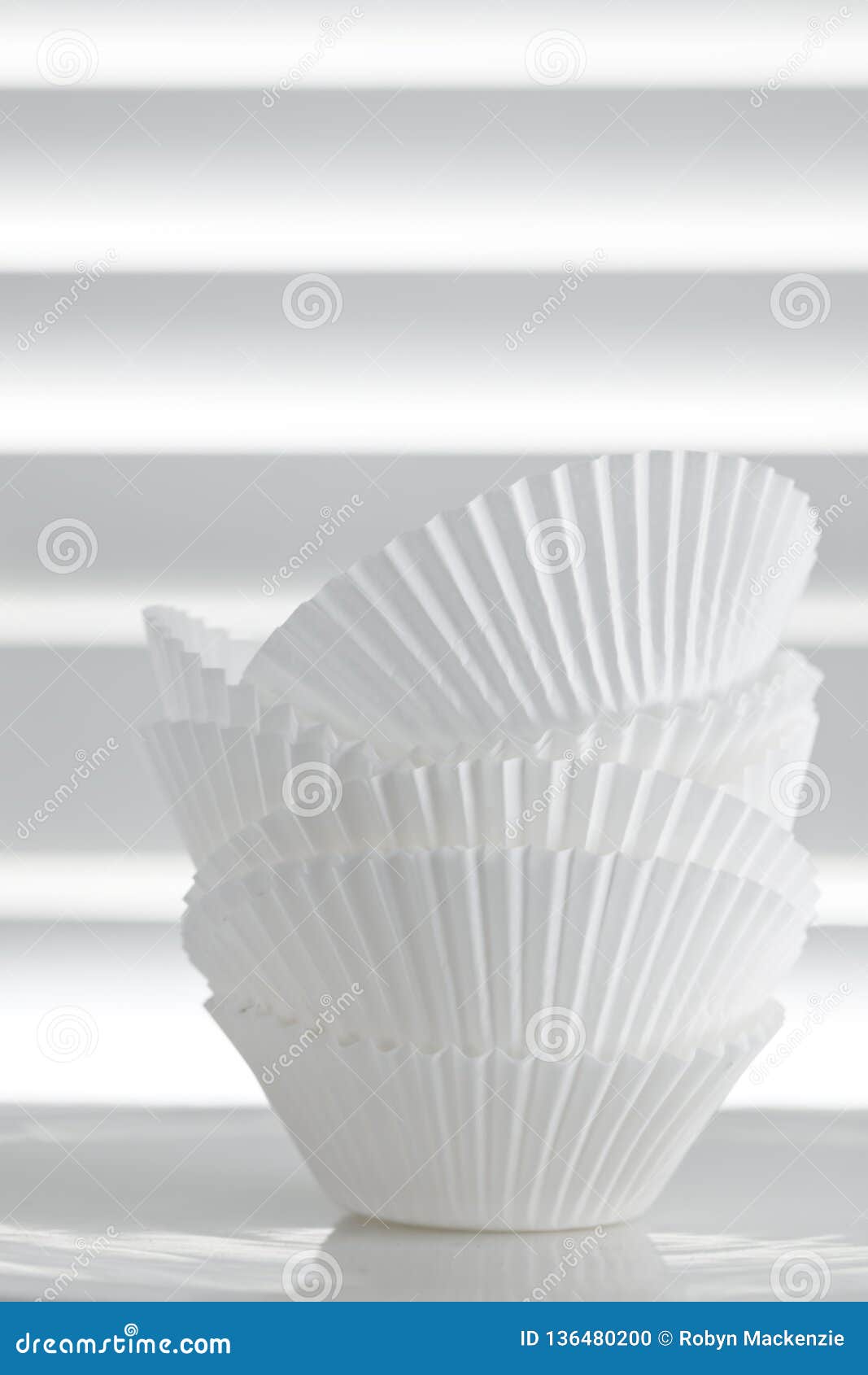 Stack of Empty Cupcake Cases Over White Slat Background Stock Photo ...