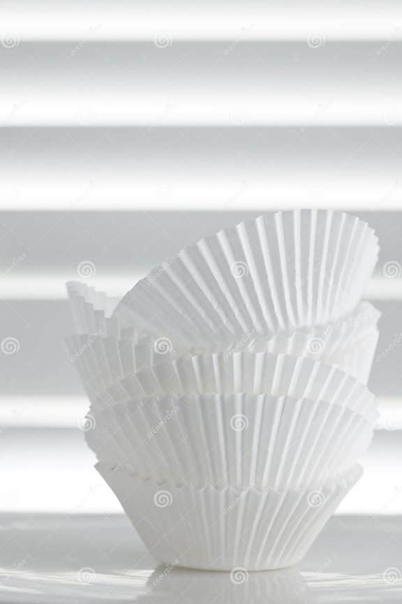 Stack of Empty Cupcake Cases Over White Slat Background Stock Photo ...