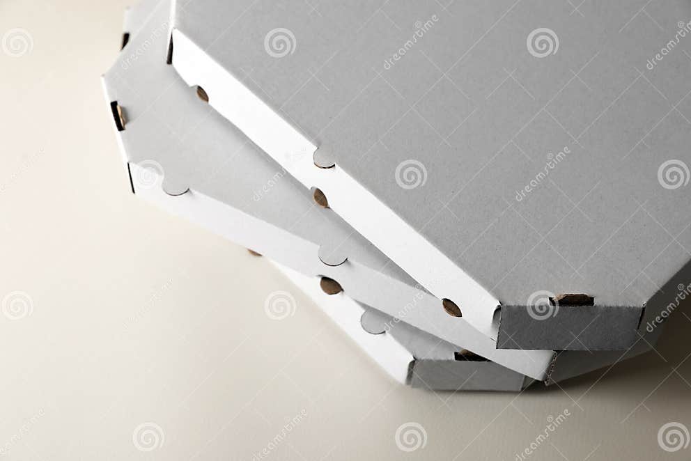 Stack of Empty Pizza Boxes on Beige Background, Closeup Stock Image ...
