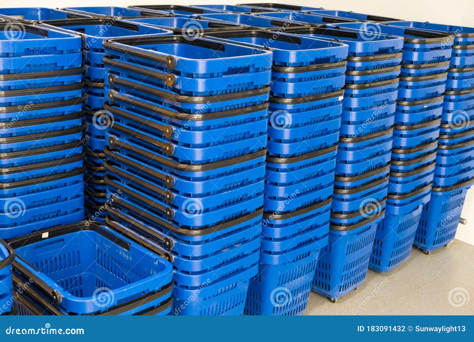 Stack of Empty Shopping Baskets in Supermarket, Closeup Stock Photo ...