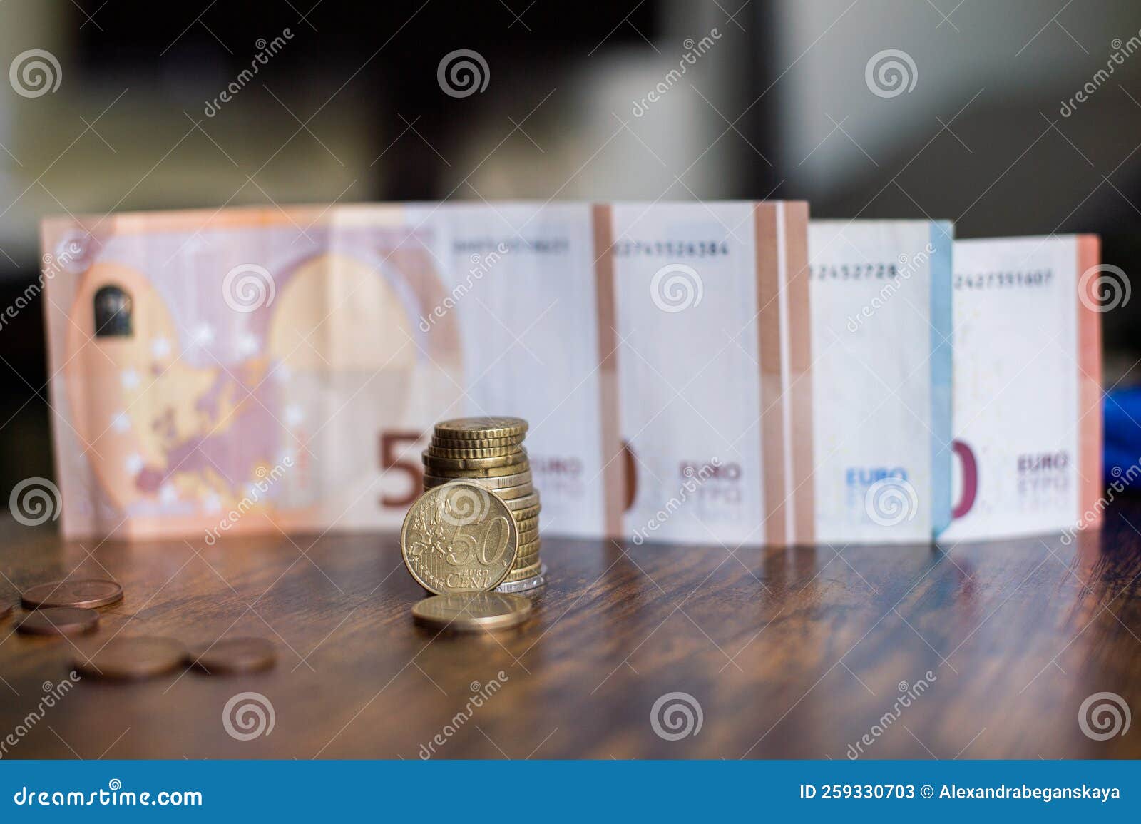 A Stack of Euro Coins Stands Against the Background of Paper Banknotes ...