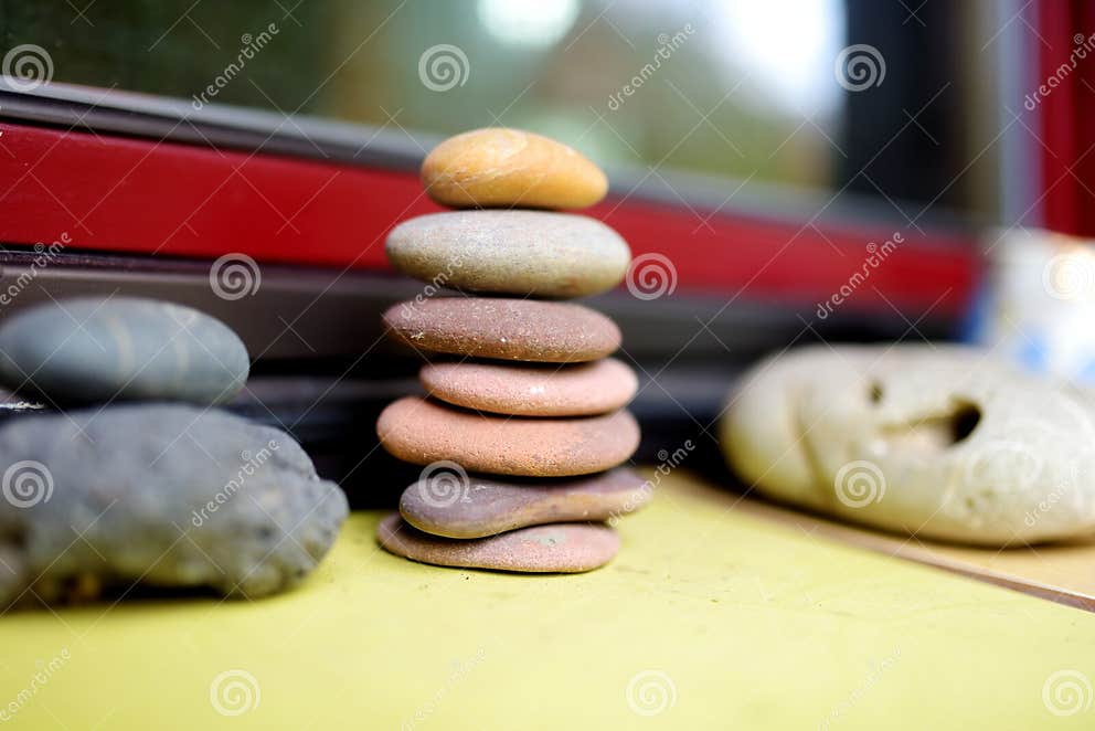 Stack of Flat Stones Balanced on a Windowsill Stock Photo - Image of ...
