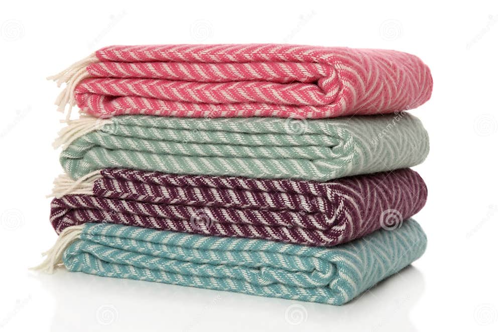 A Stack of Folded Blankets Lying on Top of Each Other Stock Photo ...