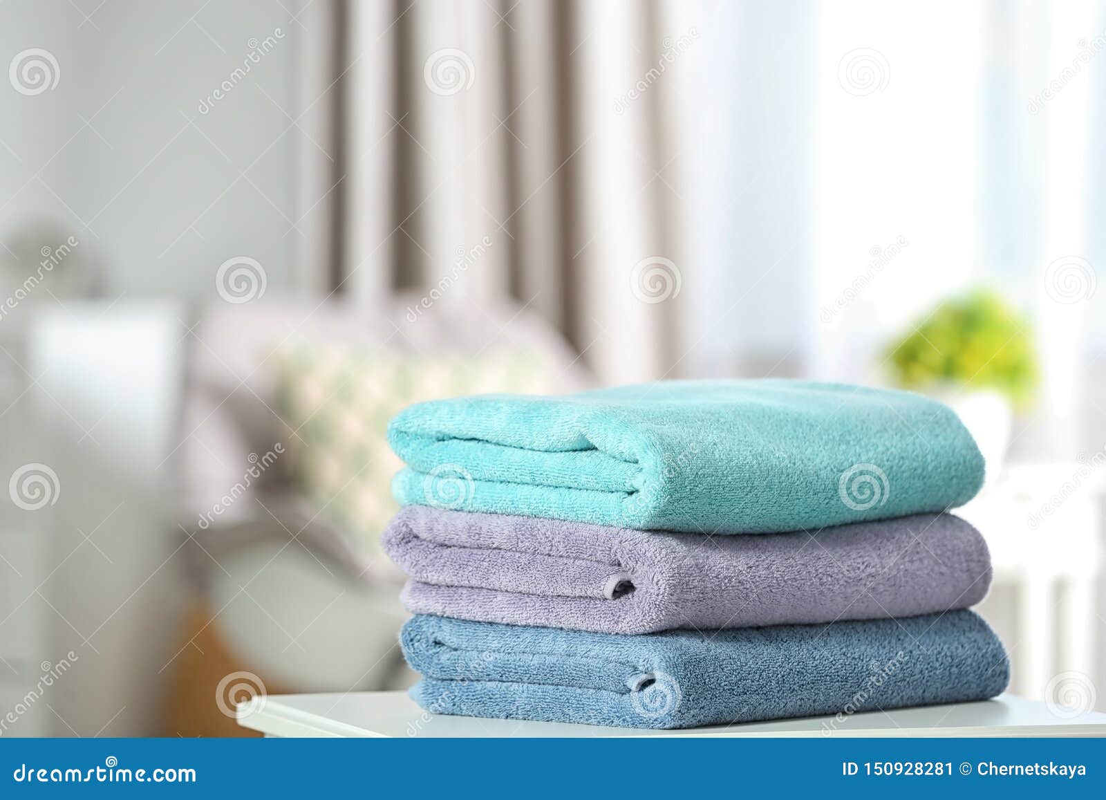 Stack of Folded Clean Soft Towels on Table Indoors Stock Image - Image ...