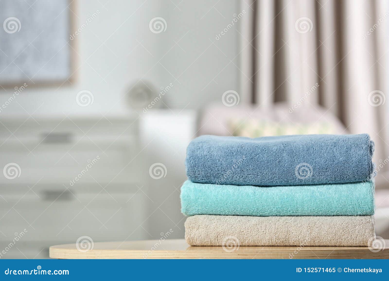 Stack of Folded Clean Soft Towels on Table Indoors Stock Image - Image ...