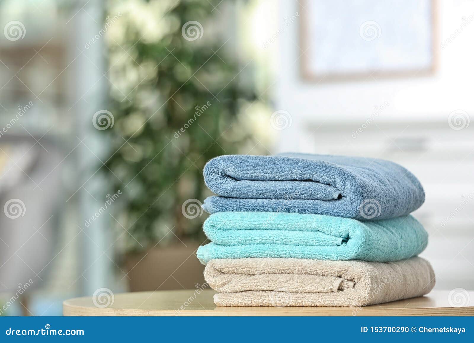 Stack of Folded Clean Soft Towels on Table Indoors Stock Photo - Image ...