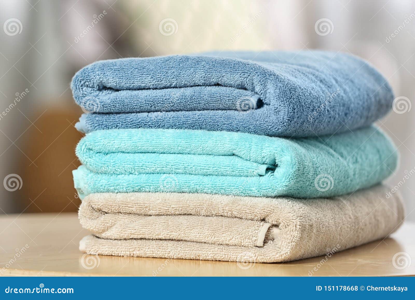 Stack of Folded Clean Soft Towels on Table Indoors Stock Photo - Image ...
