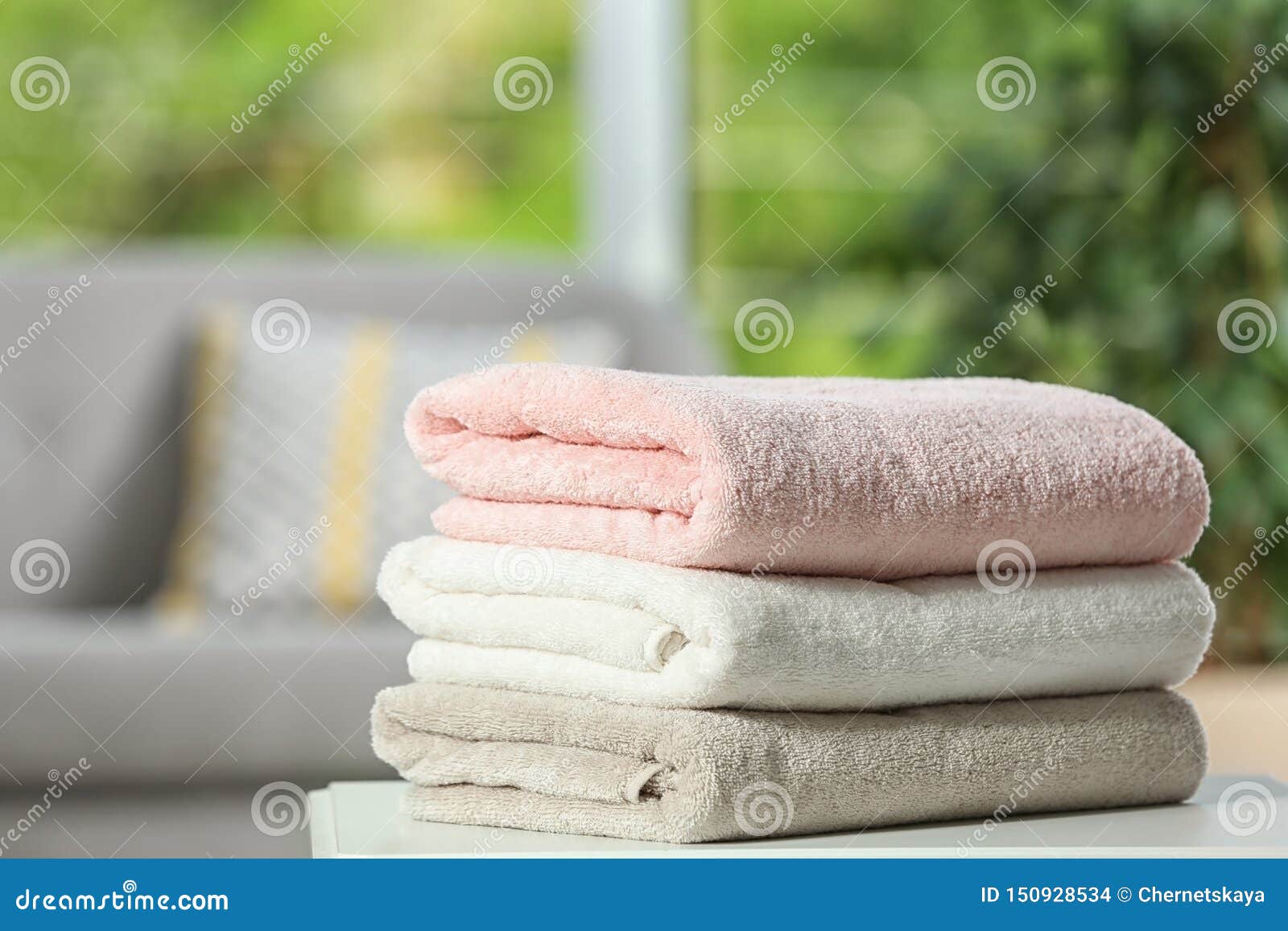 Stack of Folded Clean Soft Towels on Table. Space for Text Stock Photo ...