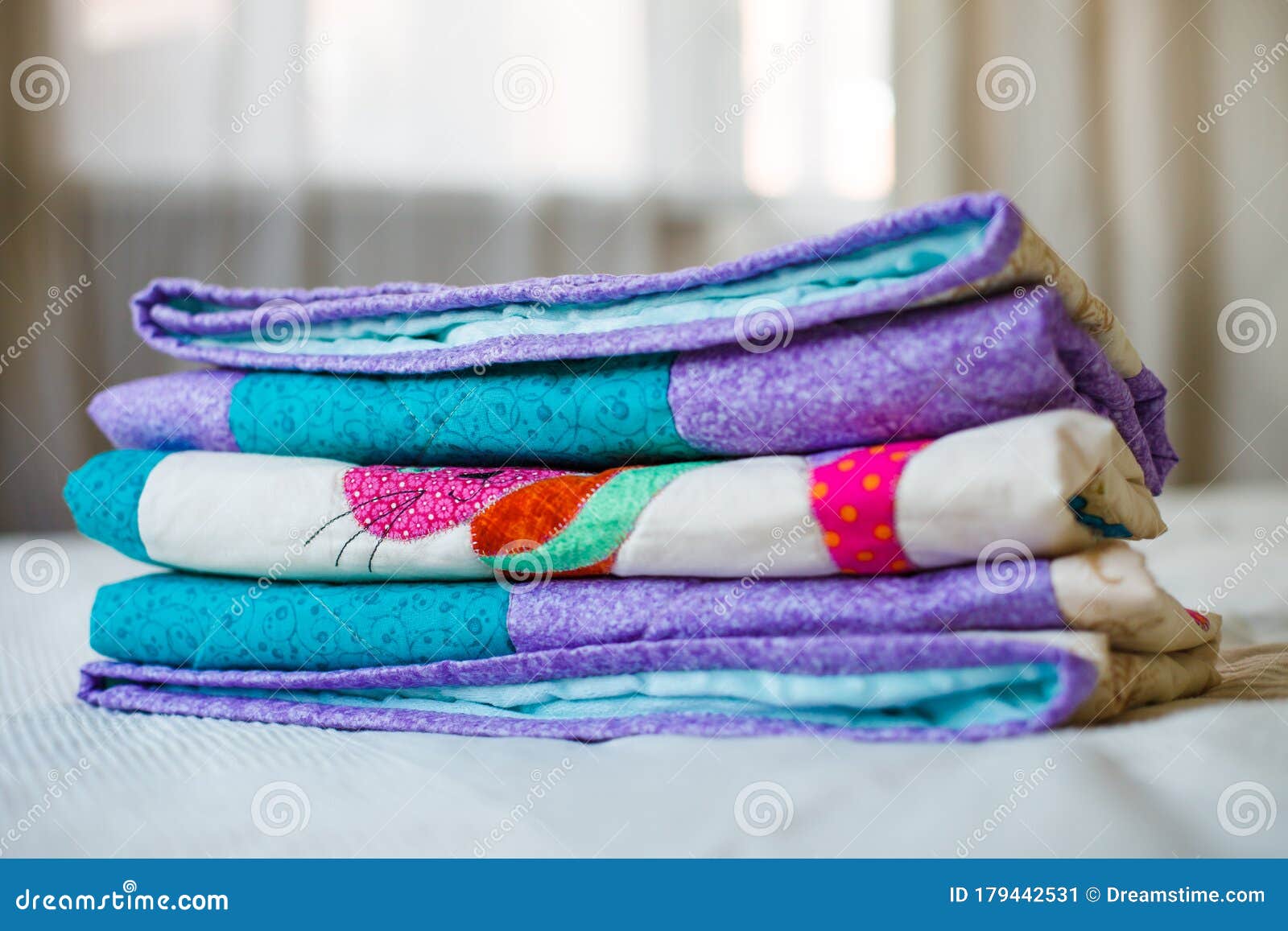 Stack of Folded Handmade Patchwork Blankets with a Blanket with a ...