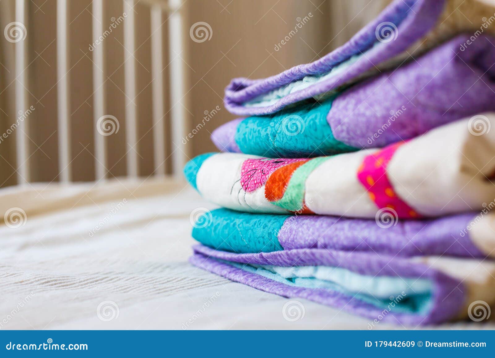 Stack of Folded Handmade Patchwork Blankets with a Blanket with a ...