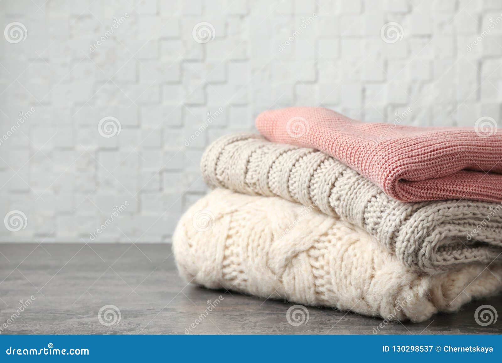 Stack of Folded Knitted Sweaters on Table Stock Image - Image of folded ...