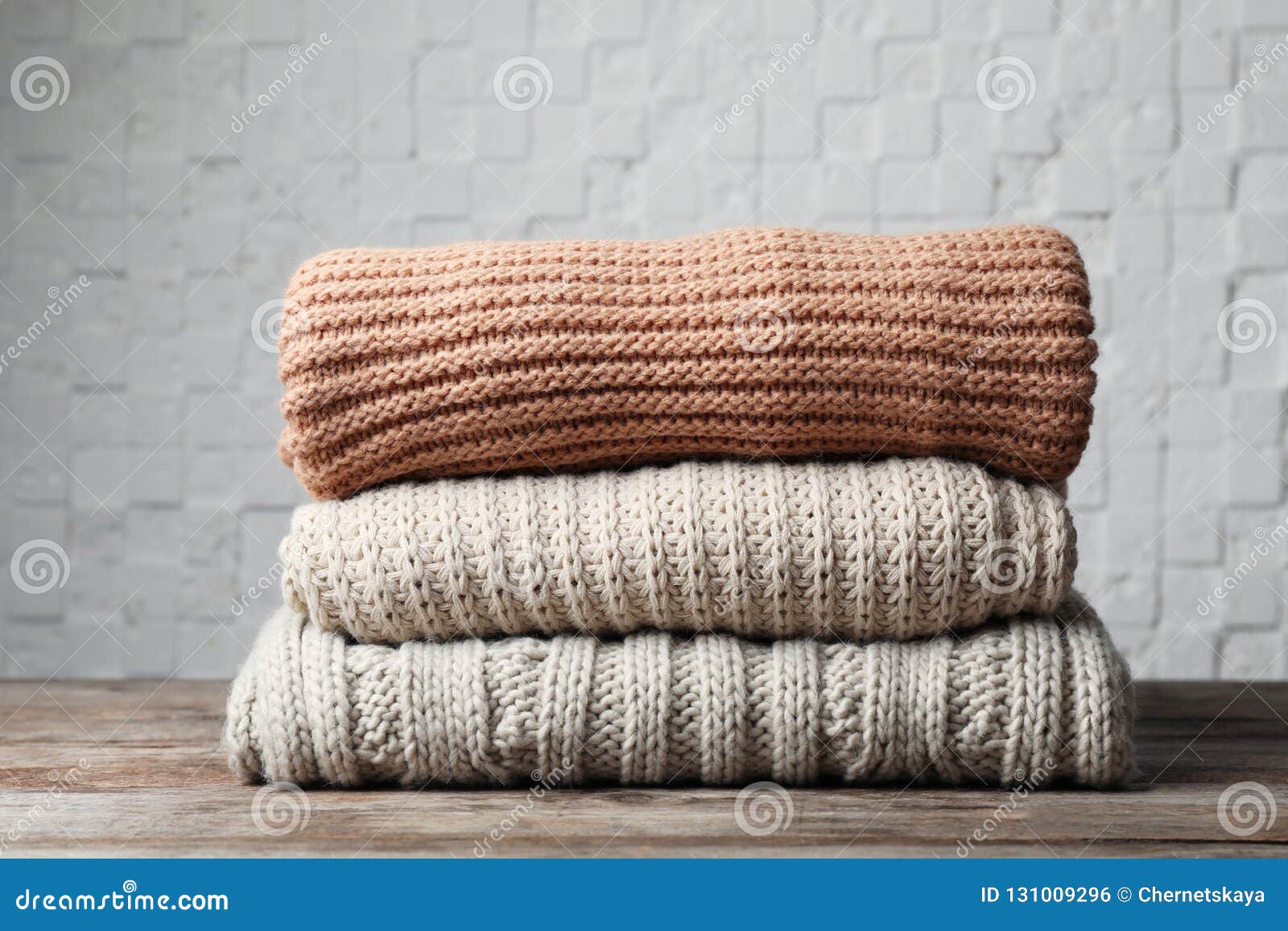 Stack of Folded Knitted Sweaters on Table Stock Photo - Image of ...
