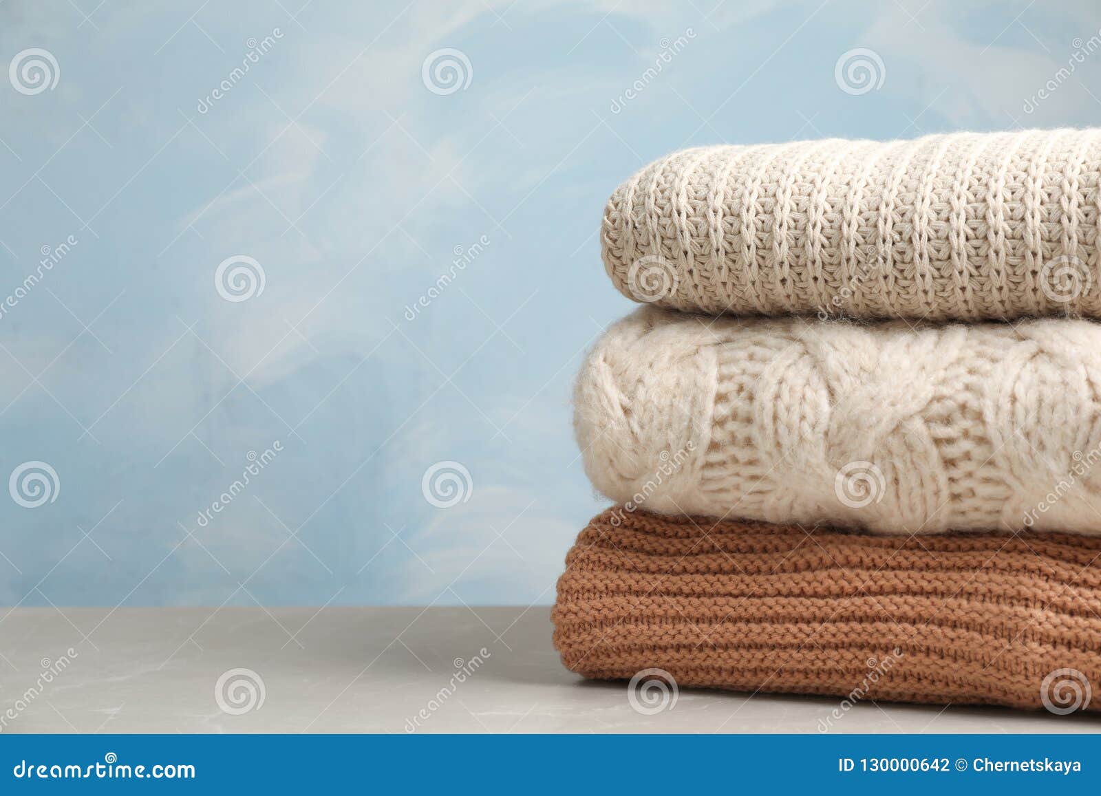 Stack of Folded Knitted Sweaters on Table Stock Photo - Image of jersey ...
