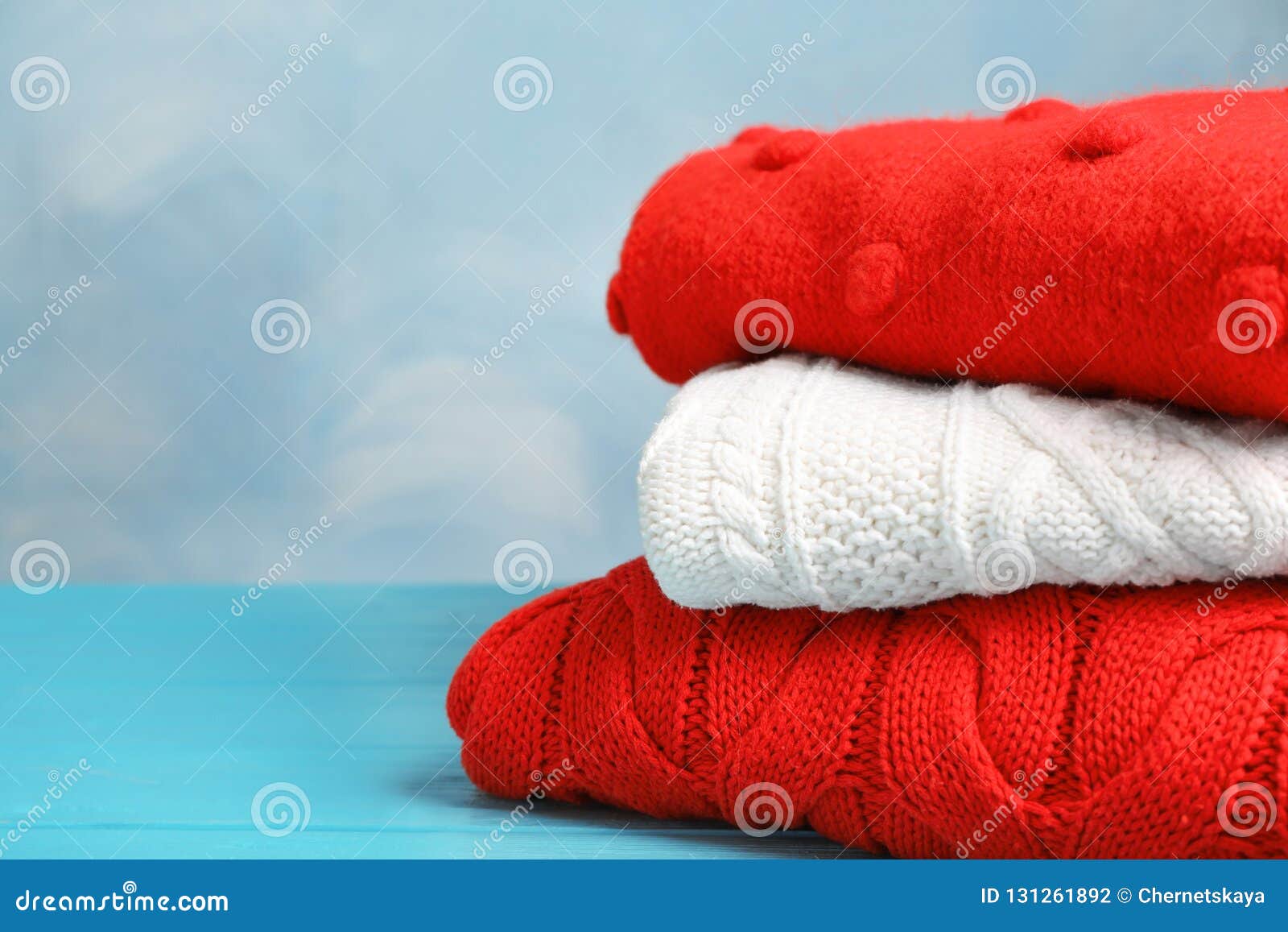 Stack of Folded Knitted Sweaters on Table Stock Photo - Image of color ...