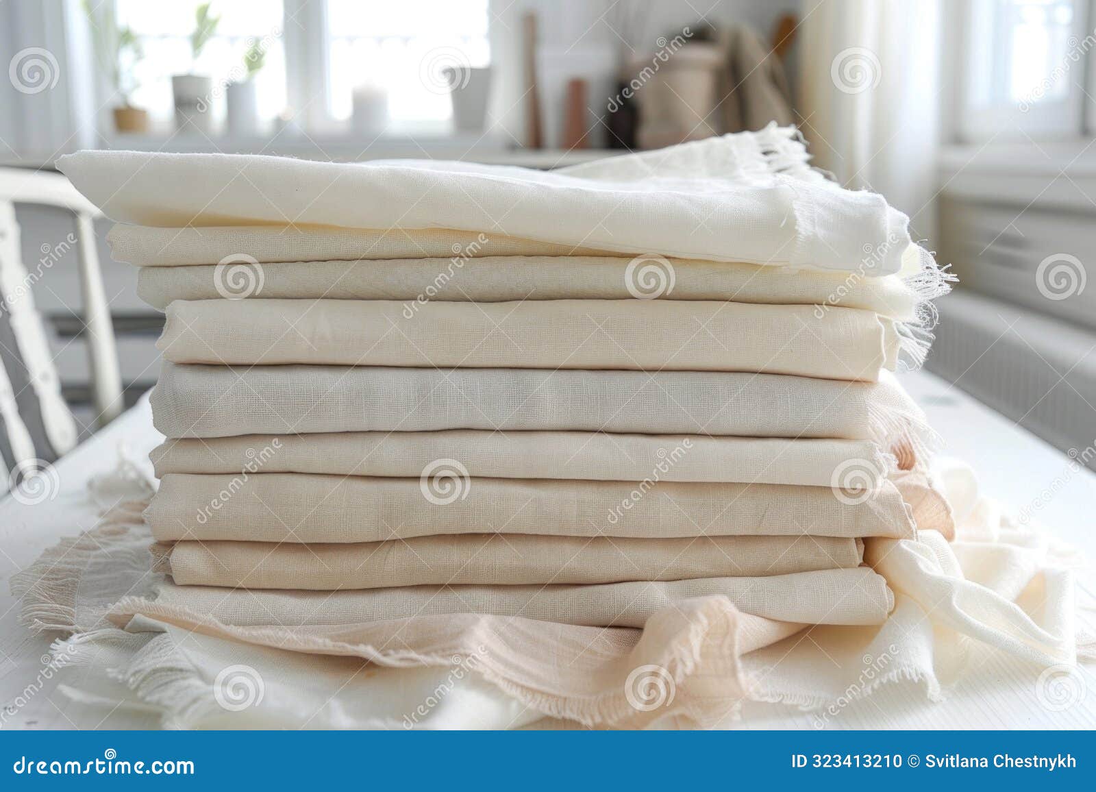Stack of Folded Natural Fabrics, on Table in Bright Room with Natural ...