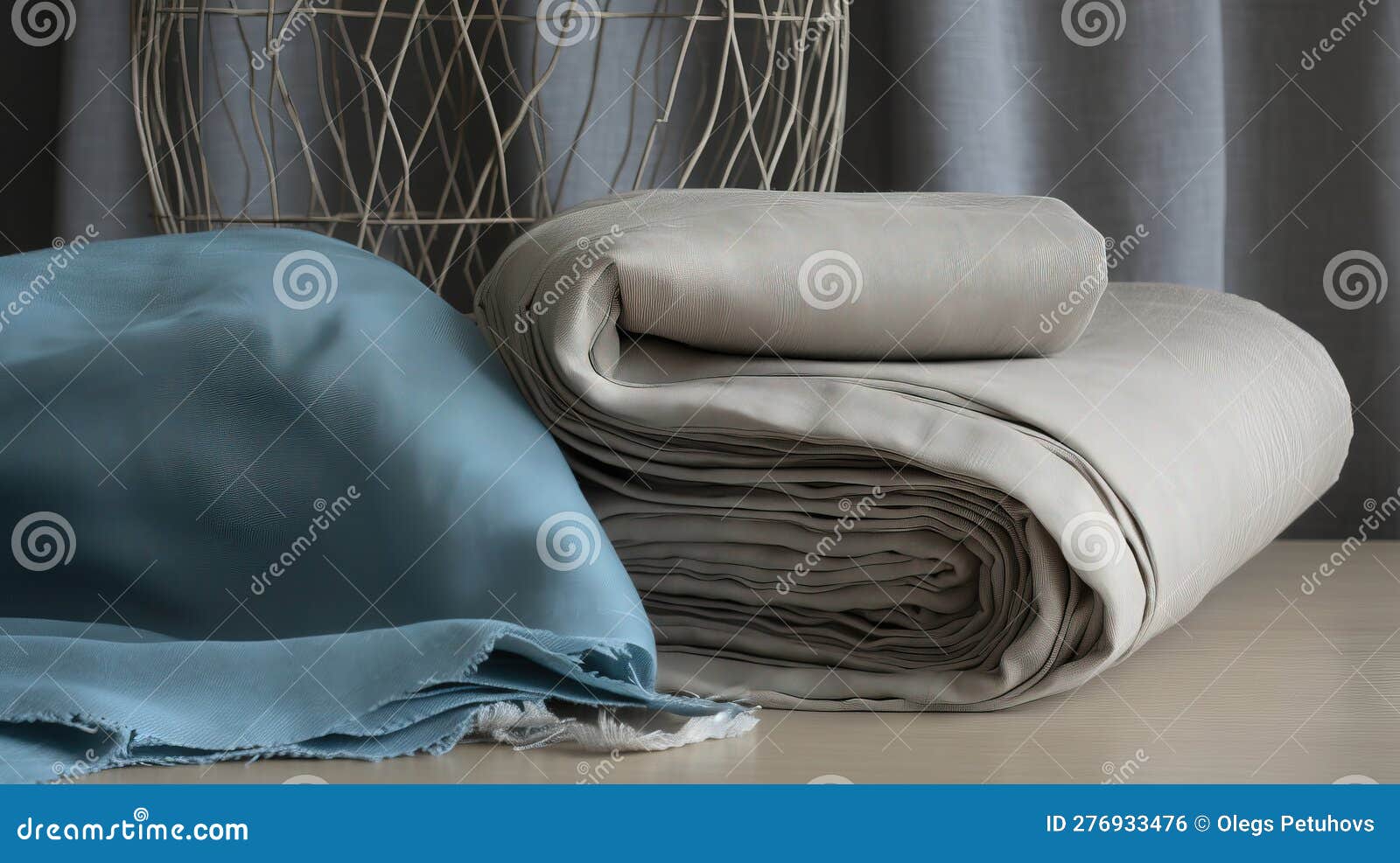 A Stack of Folded Sheets and a Basket of Folded Sheets on a Table with ...