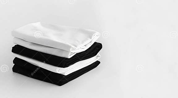 Stack of Folded T-shirts Black and White on a Plain Background. the ...