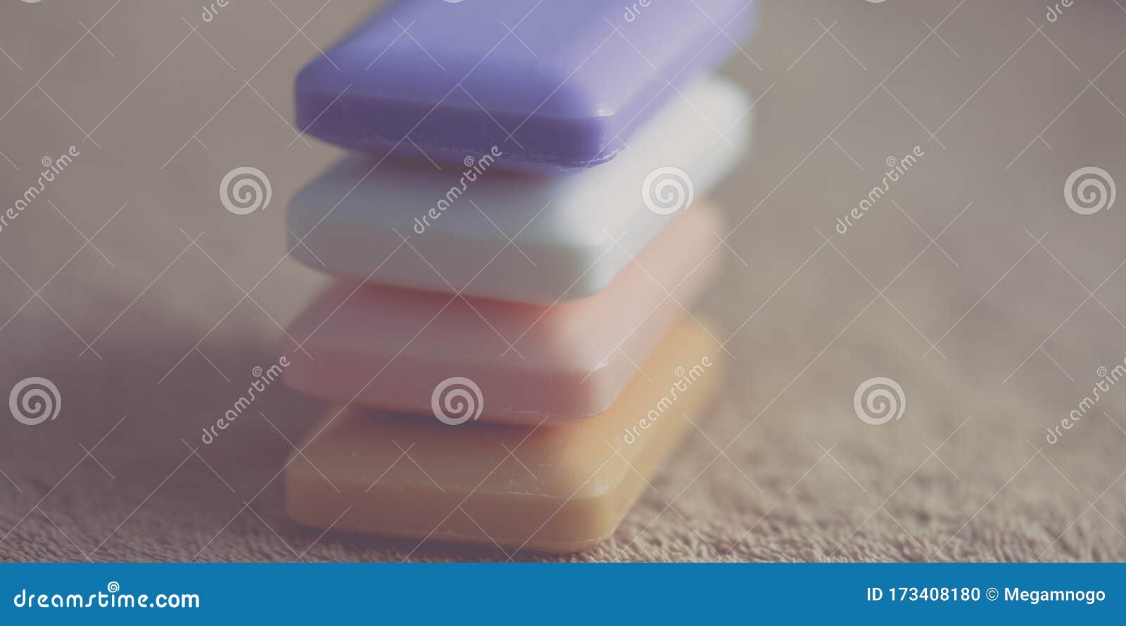 Stack of Four Bars of Soap Different Colors on a Brown Towel. Stock ...