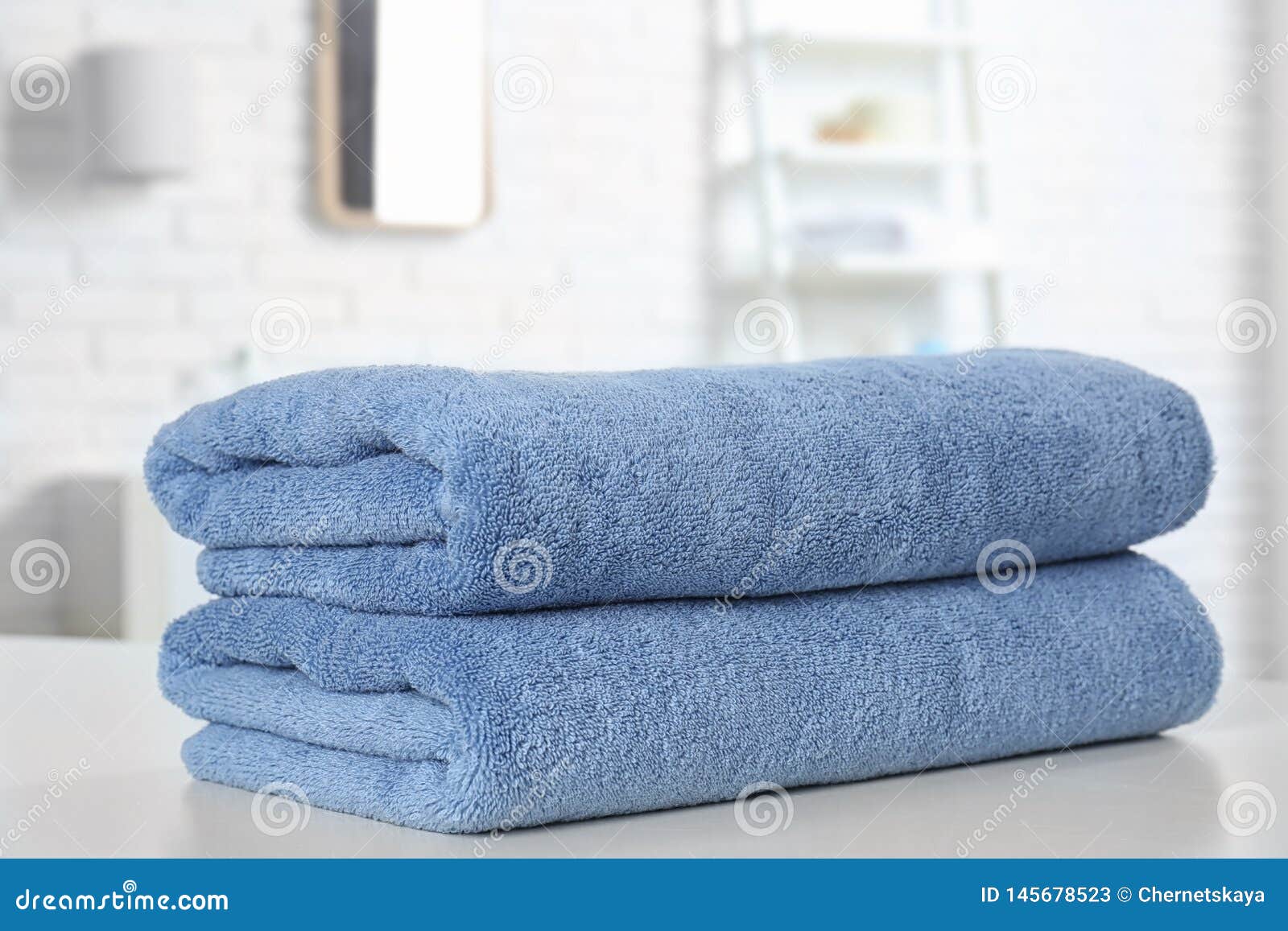 Stack of Fresh Towels on Table in Bathroom, Closeup Stock Image - Image ...