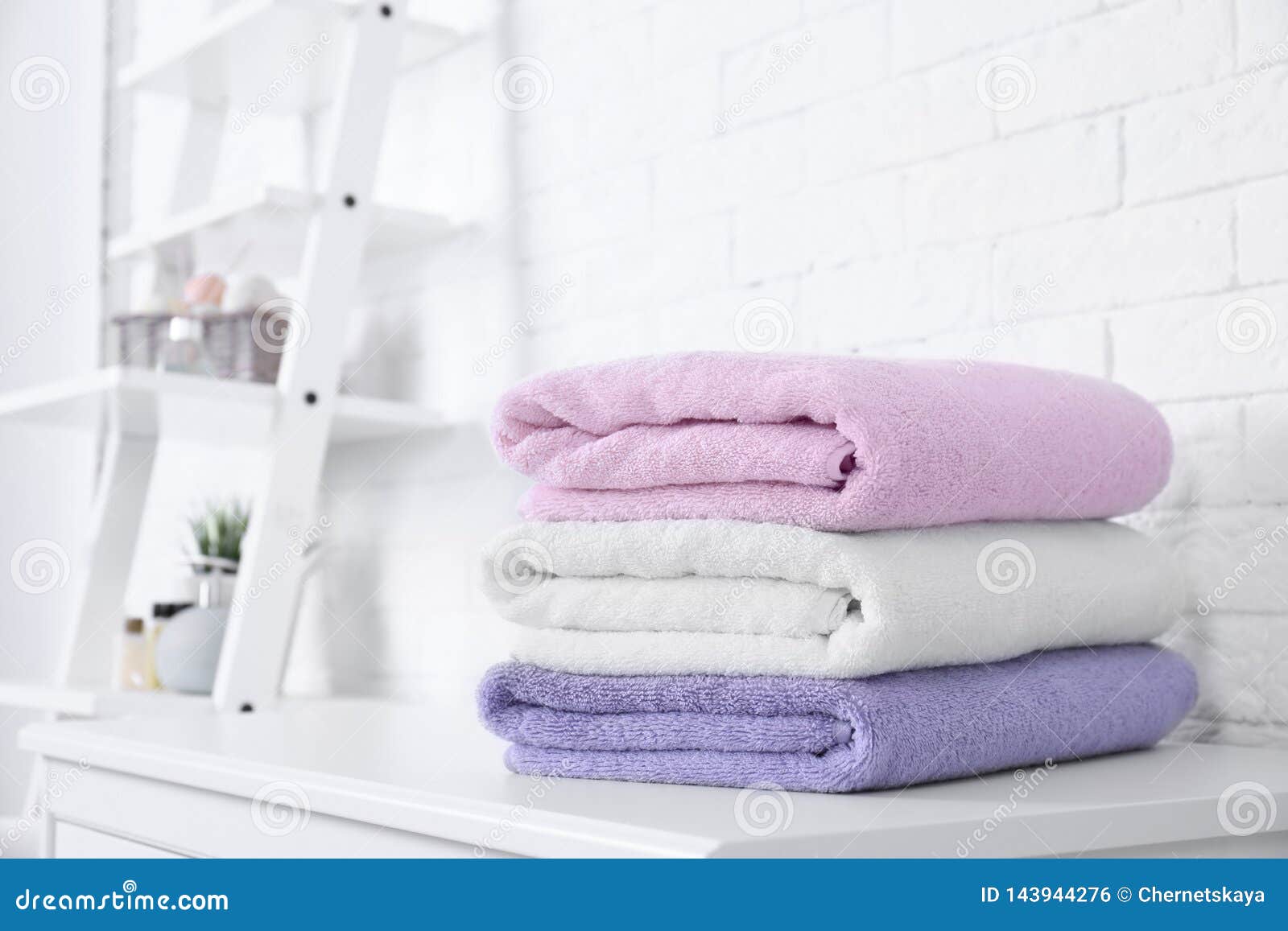 Stack of Fresh Towels on Table in Bathroom Stock Photo - Image of ...