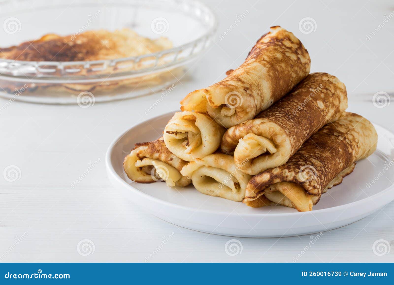 A Stack of Freshly Made Crepes on a Plate with Unrolled Ones in Behind ...