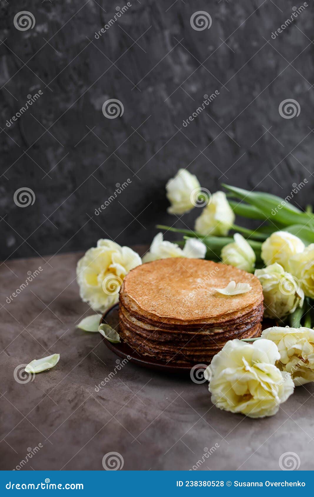 A Stack of Fried Rice Pancakes on a Table with Tulips. Stock Photo ...