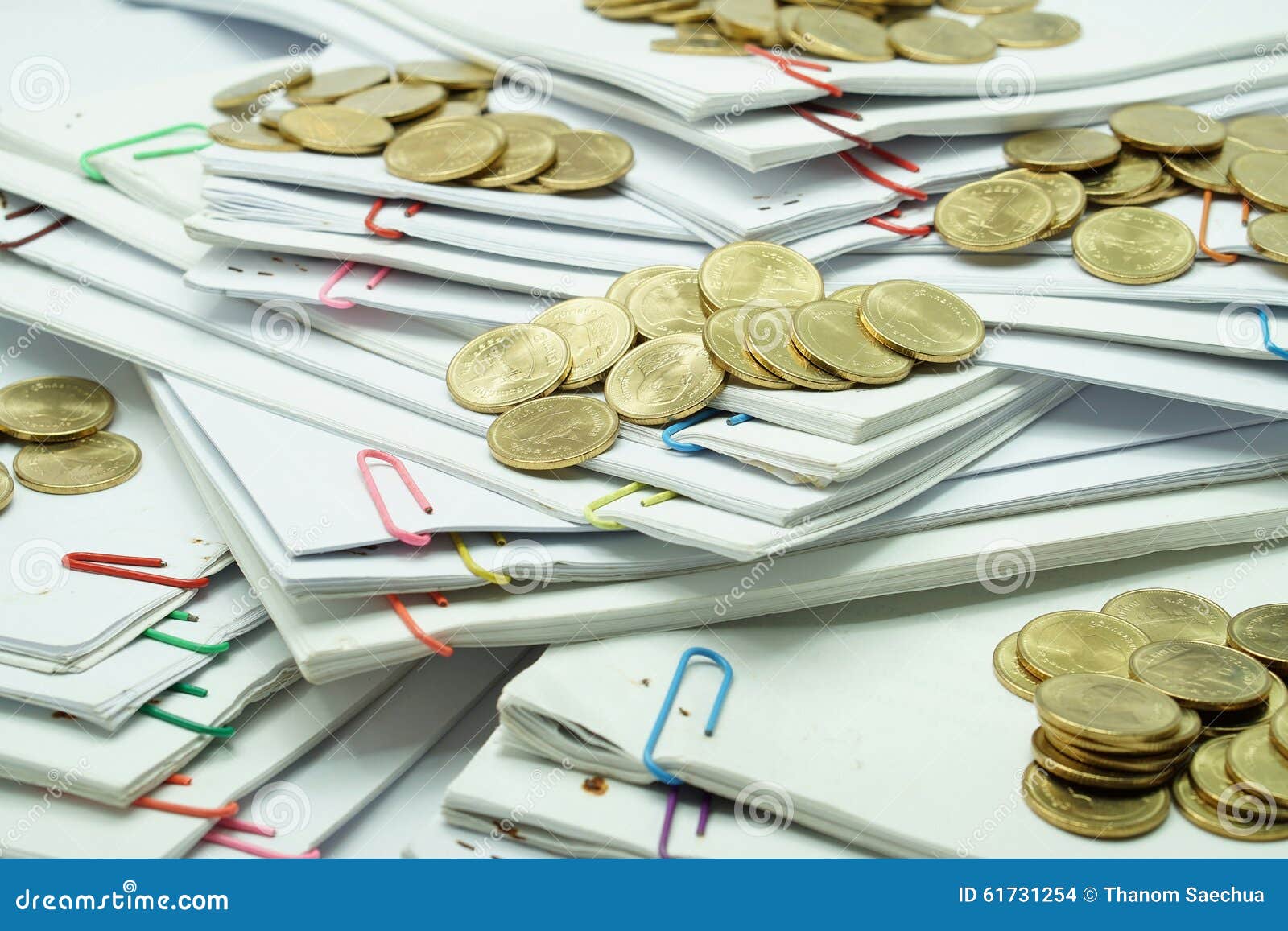 Stack of Gold Coins on Pile of White Scattered Paperwork Stock Photo ...