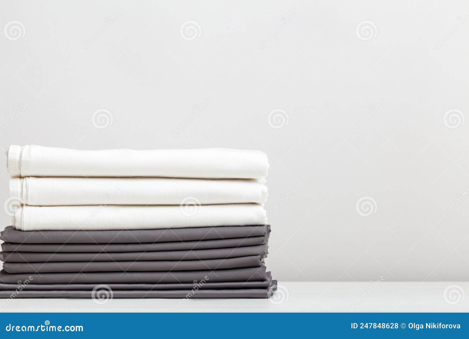 A Stack of Gray and White Bed Linens, Sheets on the Table Stock Photo ...
