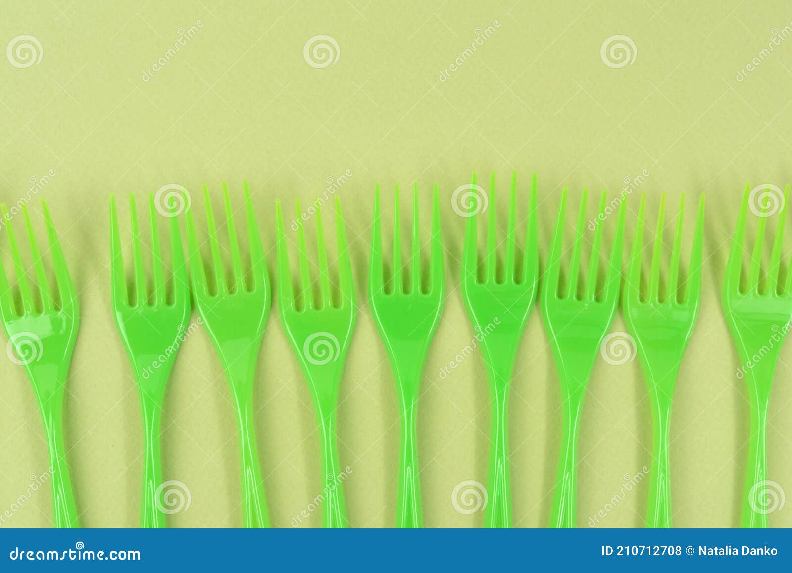 Stack of Green Plastic Forks on a Green Background Stock Photo - Image ...