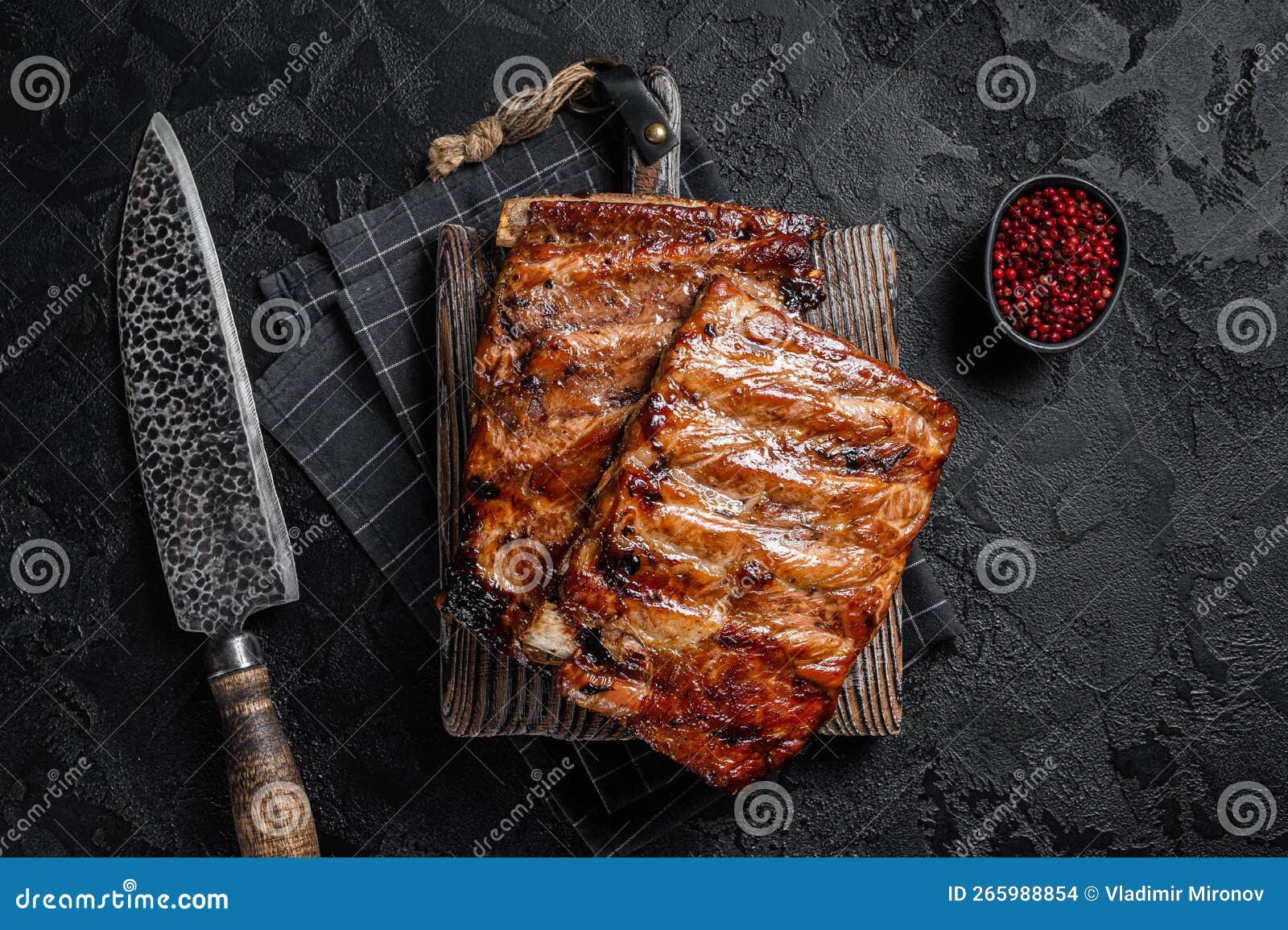 Stack of Grilled Pork Ribs in BBQ Sauce on a Chopping Board. Black ...