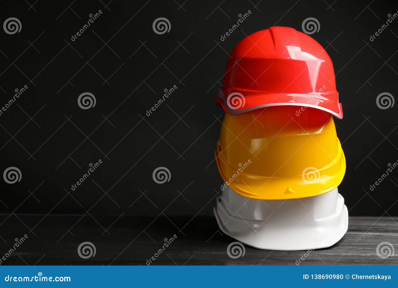 Stack Of Hard Hats And Space For Text On Black Background. Stock ...